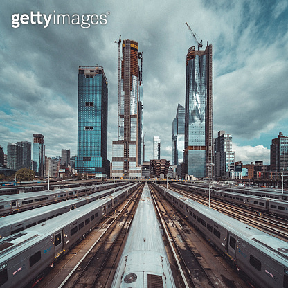 New York subway trains parked with building under construction in the ...