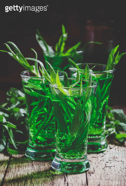 Green fizzy drink, halloween cocktail, with tarragon, vintage wooden ...