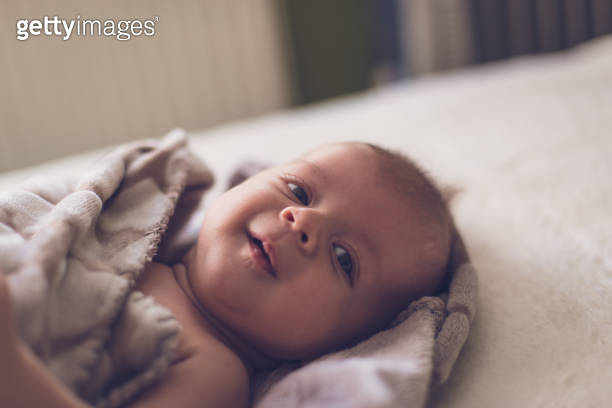 Close-up of baby boy wraped in a blanket 이미지 (945140772) - 게티이미지뱅크