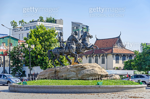 Preah Sisowath Quay with the monument to the warriors Techo Meas and ...