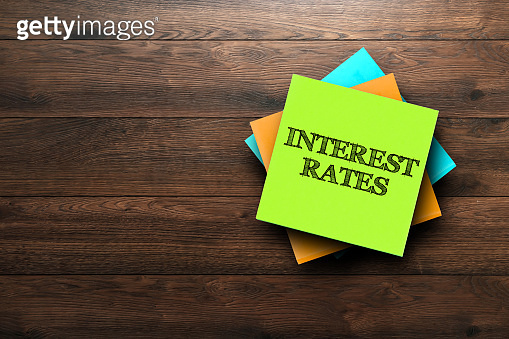 Interest Rates, the phrase is written on multi-colored stickers, on a ...