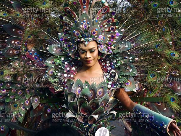 A participant in her colorful costume at a parade during the Sumaka ...