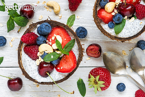 Vegan coconut milk chia seeds pudding with fresh berries, nuts and mint ...