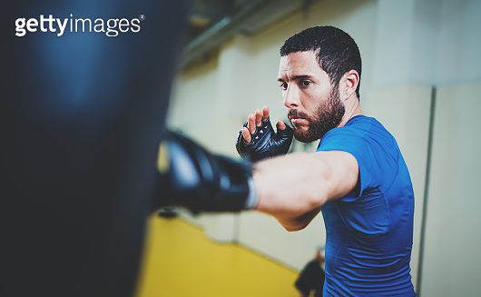 Concept of a healthy lifestyle.Bearded muscular man fighter practicing ...
