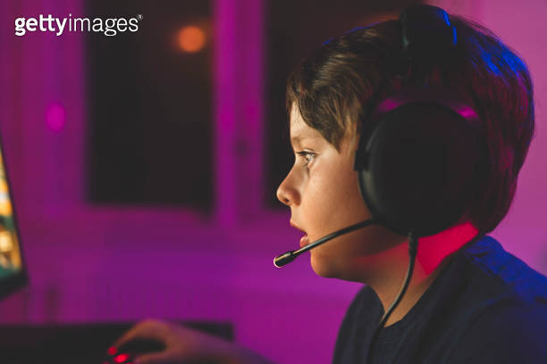 Young boy playing games on a computer at home 이미지 (1065007578) - 게티이미지뱅크