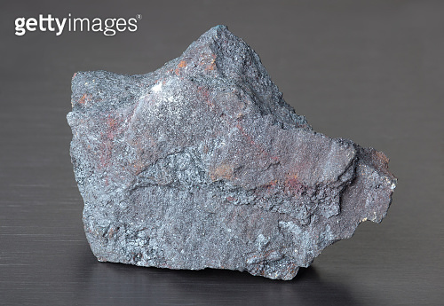 Specimen of mineral haematite on gray background. Haematite is mined as ...