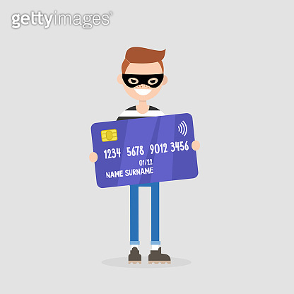 Stealing money. Thief in a black mask holding a credit card. Theft ...