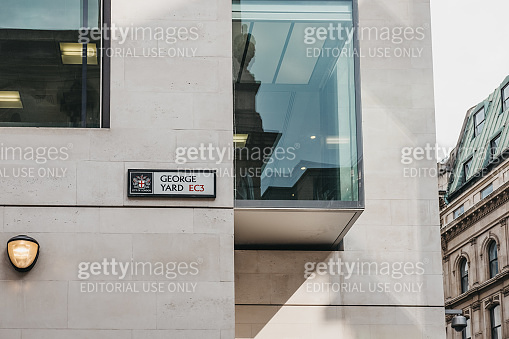 Street name sign on a side of a building on George Yard, City of London ...