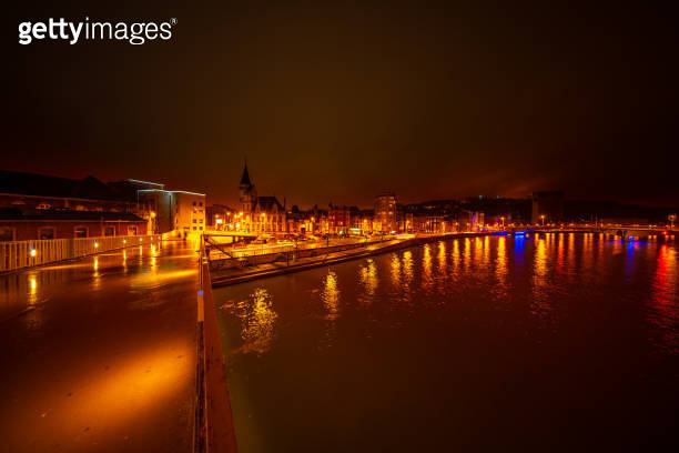 Liege river bridge, buildings, and lights of the city at night, Belgium ...