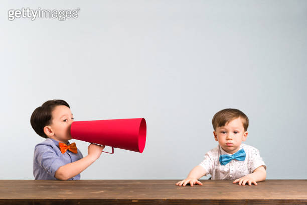 Child is shouting through megaphone to another child 이미지 (946043744 ...