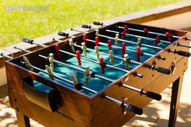 Cropped image playing foosball while resting outdoors 이미지 (1016546630 ...