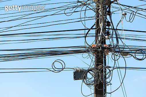 Wire assemblage a lot of cables and wires on pole in the city against ...