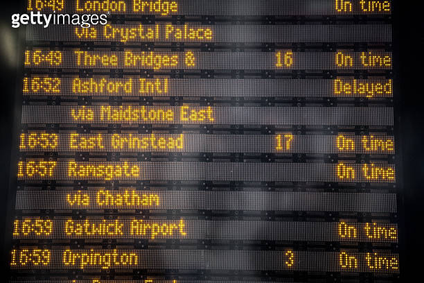 Digital screen displaying train departure times and delays in London ...