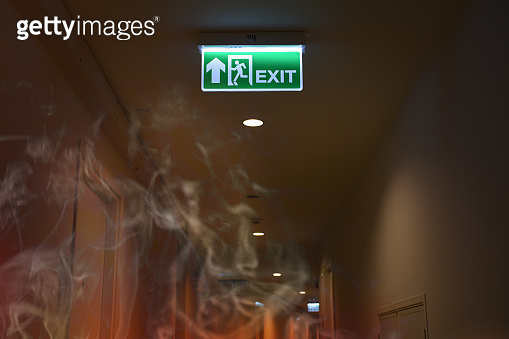 Emergency fire exit sign show the way to escape with the smoke fire ...