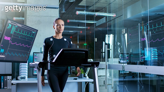 Beautiful Woman Athlete with Electrodes Connected to Her Body Walks on ...