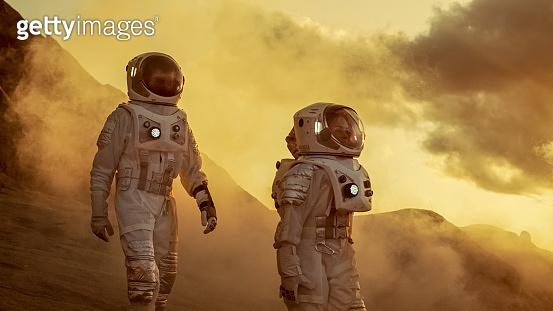 Two Astronauts in Space Suits Confidently Walking on Mars, Exploration Expedition on the Planet ...