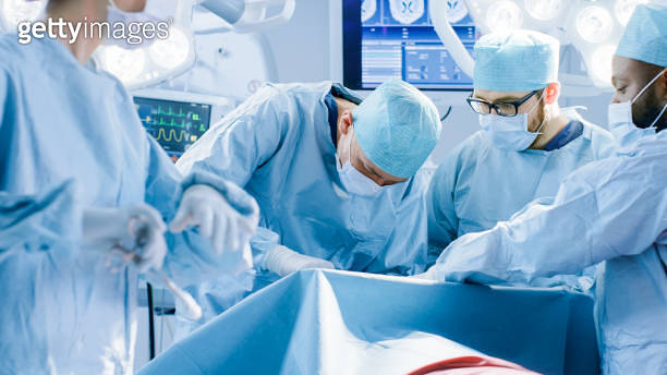 Diverse Team of Professional surgeon, Assistants and Nurses Performing ...