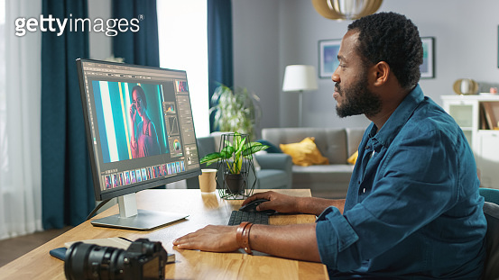 Professional Photographer Works in Photo Editing App / Software on His ...