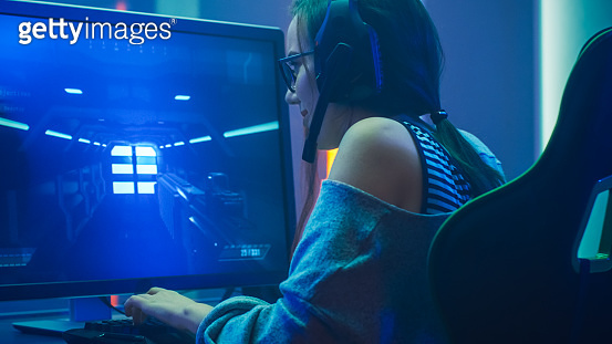 Shot of the Beautiful Pro Gamer Girl Playing in FPS Video Game on Her ...