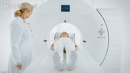 In Medical Laboratory Female Radiologist Controls MRI or CT or PET Scan ...