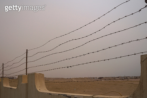 Restrictive fence with barbed wire. Tour area conc camp. Genocide ...