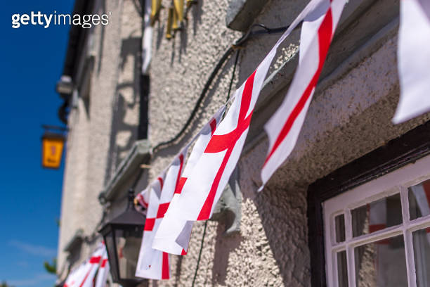 English flags hang outside a pub in the charming village of Hawskhead ...