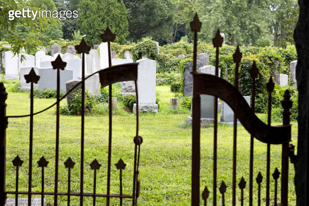 Iron Cemetery Gates beckoning, with grave stones in background 이미지 ...