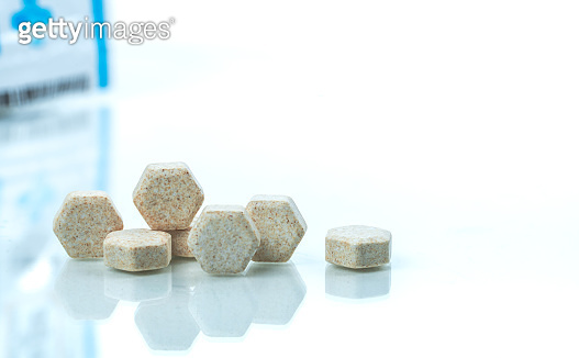 Macro shot detail of brown hexagon medical lozenges with Brazilian ...