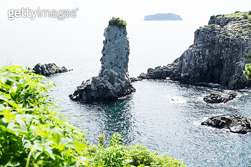 Rock formation Oedolgae in the illuminated ocean at Seogwipo, Jeju ...