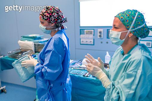 Surgery assistant and nurse laughing in the operating room (1023738352 ...