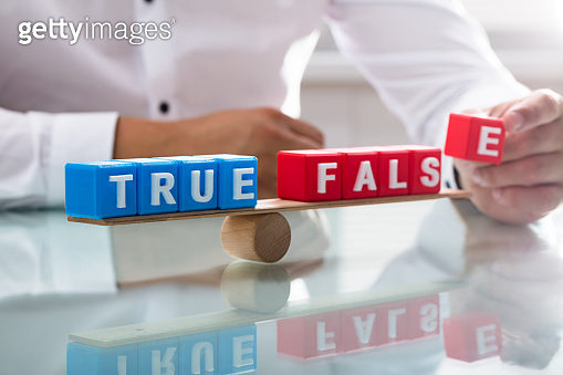 Businessman balancing true and false blocks on seesaw 이미지 (1000964594 ...