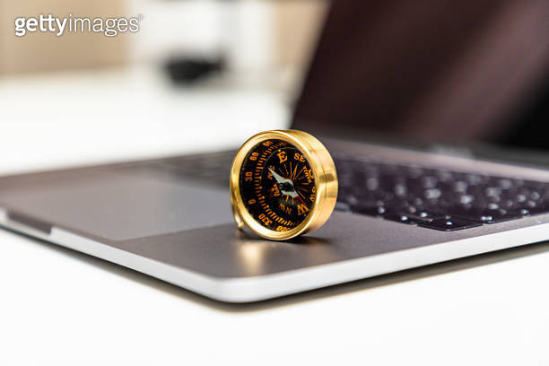 Compass and laptop as a symbol of orientation and goals on the Internet ...