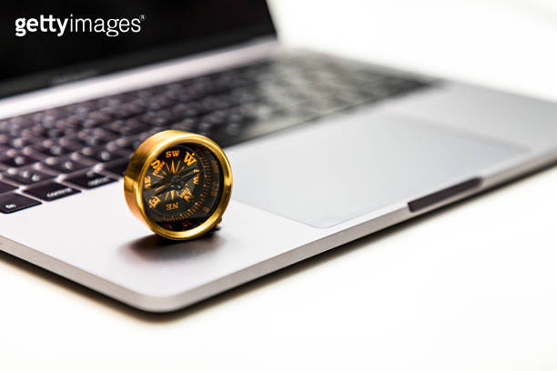 Compass and laptop as a symbol of orientation and goals on the Internet ...