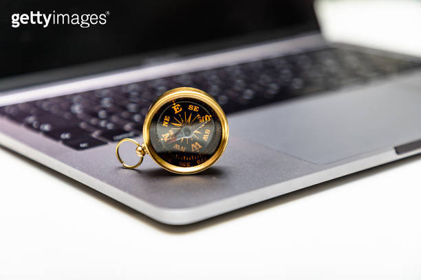 Compass and laptop as a symbol of orientation and goals on the Internet ...