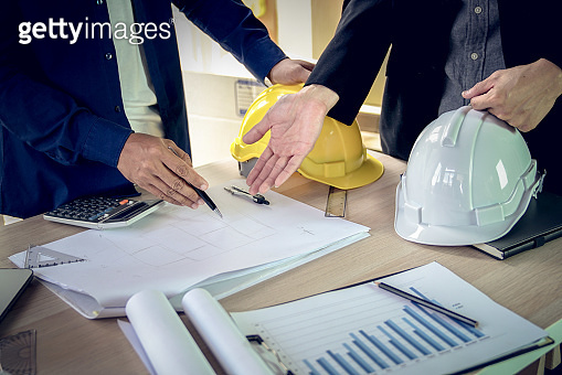 Engineer and architect working document about progress of work schedule ...