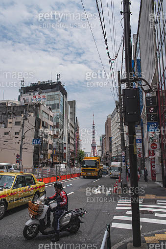 View of Tokyo tower from the streets nearby. With traffic, roads and ...