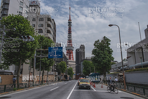 View of Tokyo tower from the streets nearby. With traffic, roads and ...