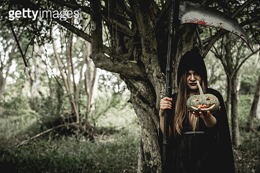 Asian woman dress black as Grim Reaper of death and holding or wielding ...