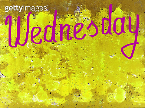 Word Wednesday written by hand with a brush in purple on a textured ...