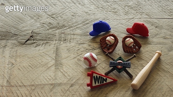 baseball bat, hats and gloves with a win banner on a natural wood ...