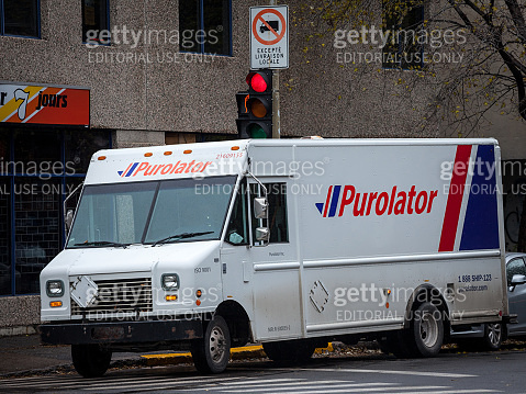 Purolator logo on one of their delivery trucks in a street of Montreal ...