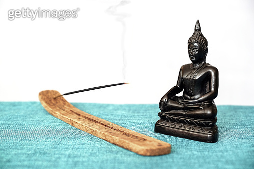 A decorative statue of Buddha, Buddha on the background of incense ...