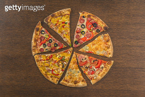 four different parts of pizza with knife on the wooden table 이미지 ...