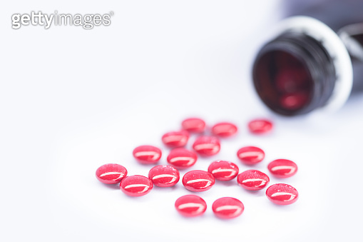 Pills Bottle with Red Vitamins inside on white background , zinc ...