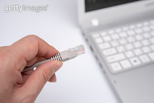 Closeup hand connection cable network connection to a Lan port of a ...