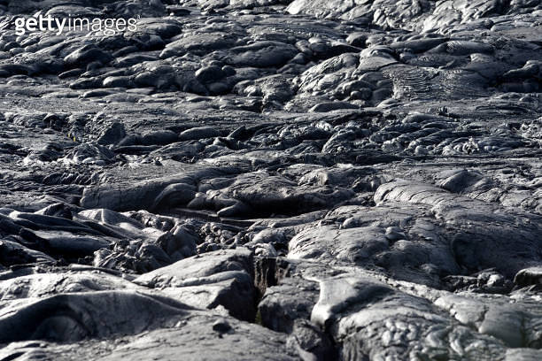Smooth, undulating surface of frozen pahoehoe lava. Frozen lava ...