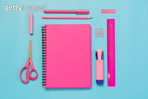 Pink girlish school supplies, notebooks and pens on punchy blue. Top ...