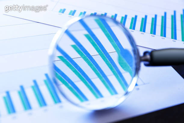 Magnifying Glass On Top Of Bar Chart Showing Positive Performance ...