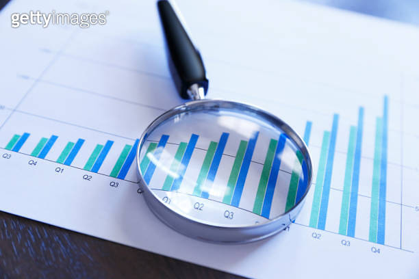 Magnifying Glass On Top Of Bar Chart Showing Positive Performance ...
