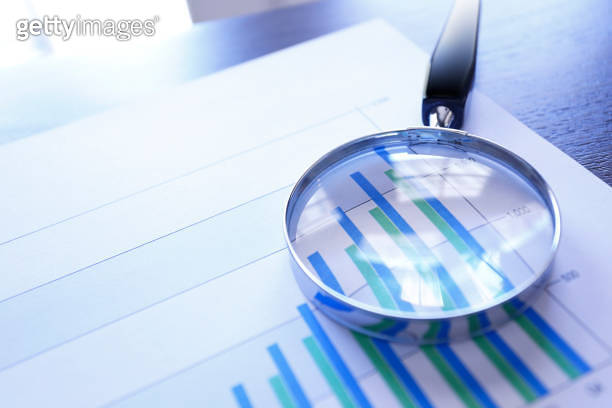 Magnifying Glass On Top Of Bar Chart Showing Positive Performance ...